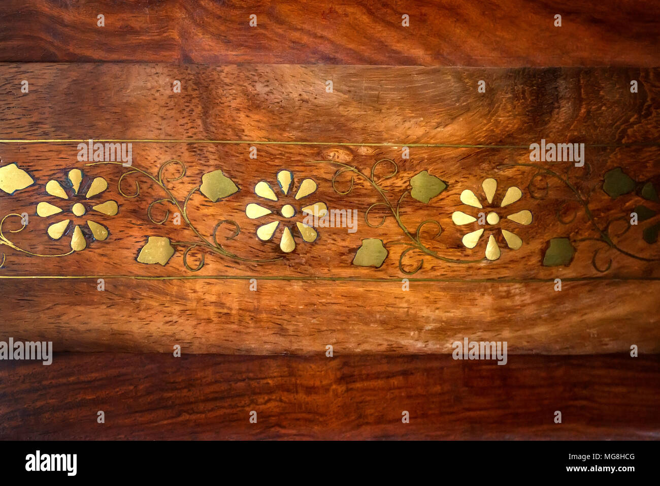 Texture expensive mahogany inlaid yellow metal Stock Photo - Alamy