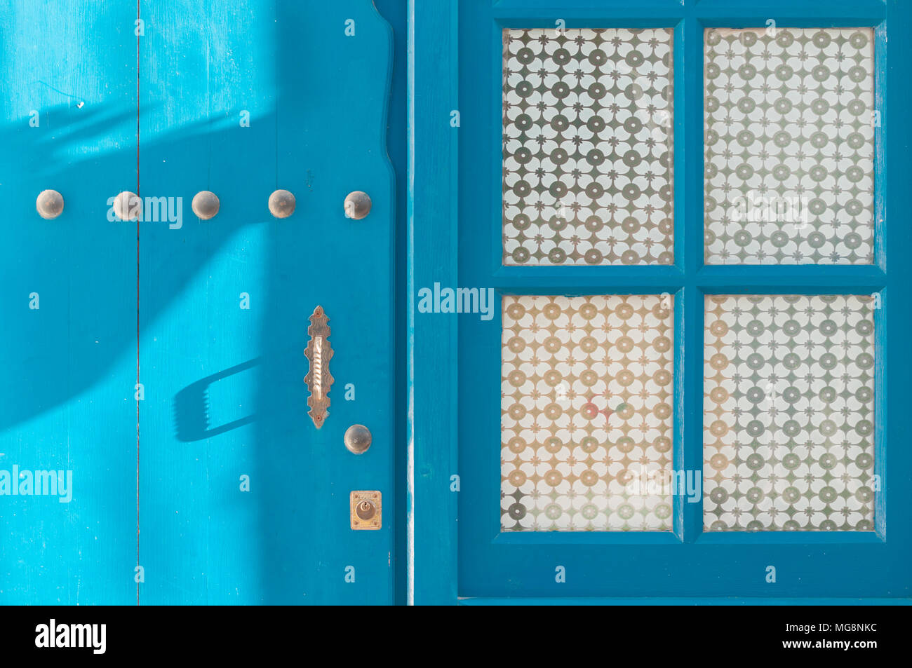Mediterranean wooden blue door with square window Stock Photo - Alamy