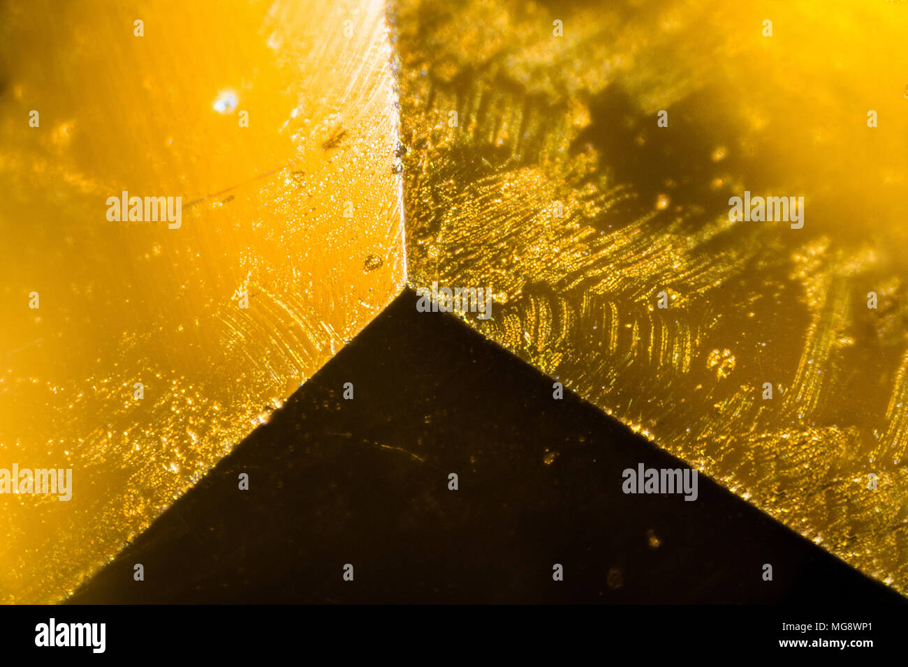 Yellow gem under the microscope. Closeup macro photography Stock Photo ...