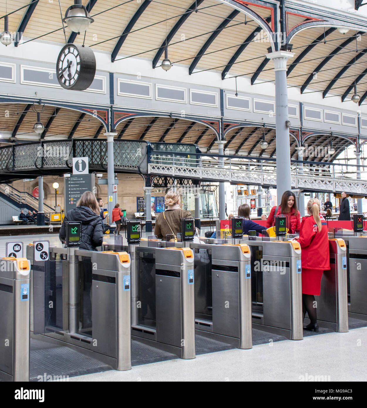 Passengers entering the platform via turnstiles supervised by Virgin ...