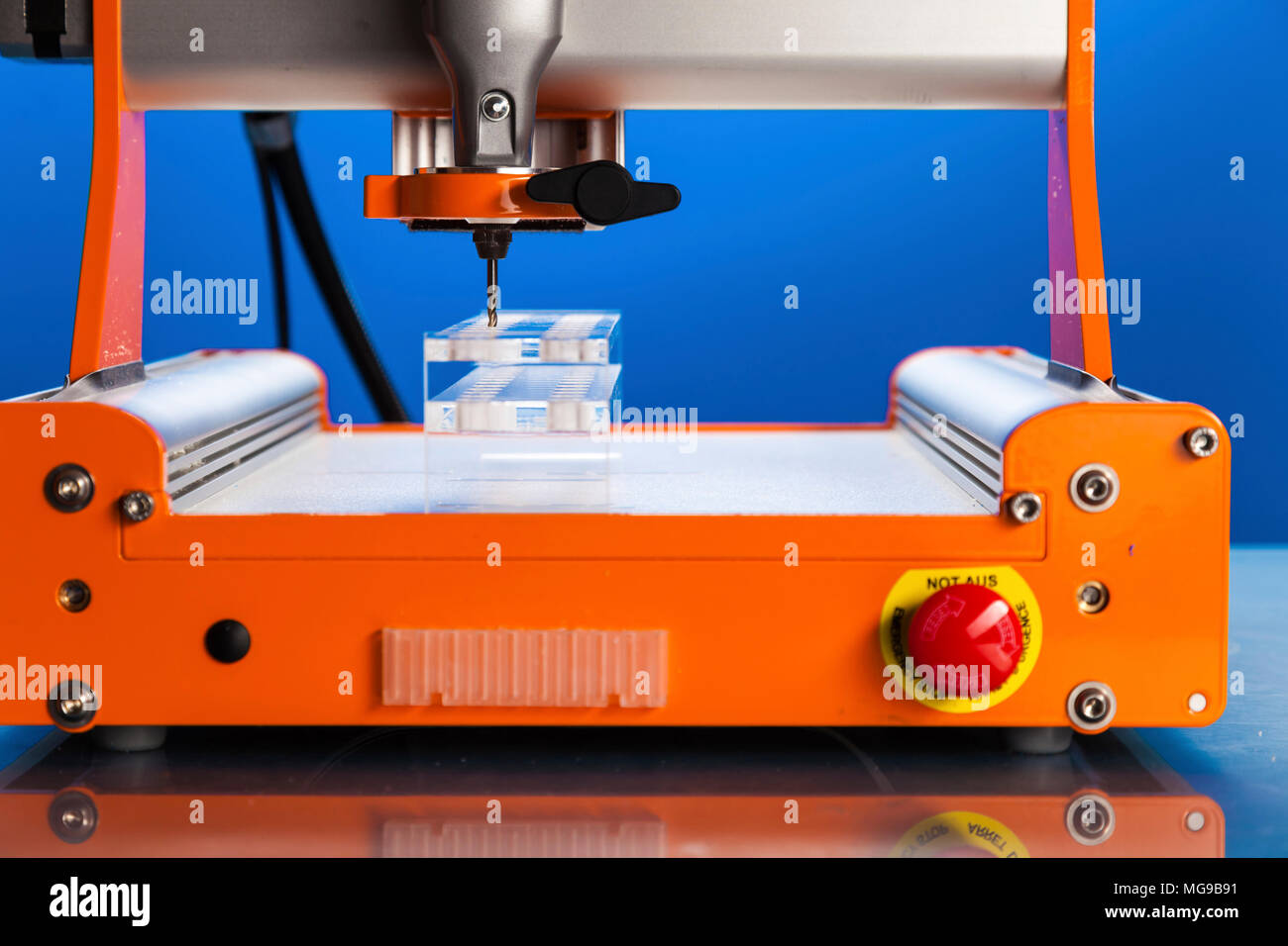 CNC milling machine drilling plastic block# Stock Photo - Alamy