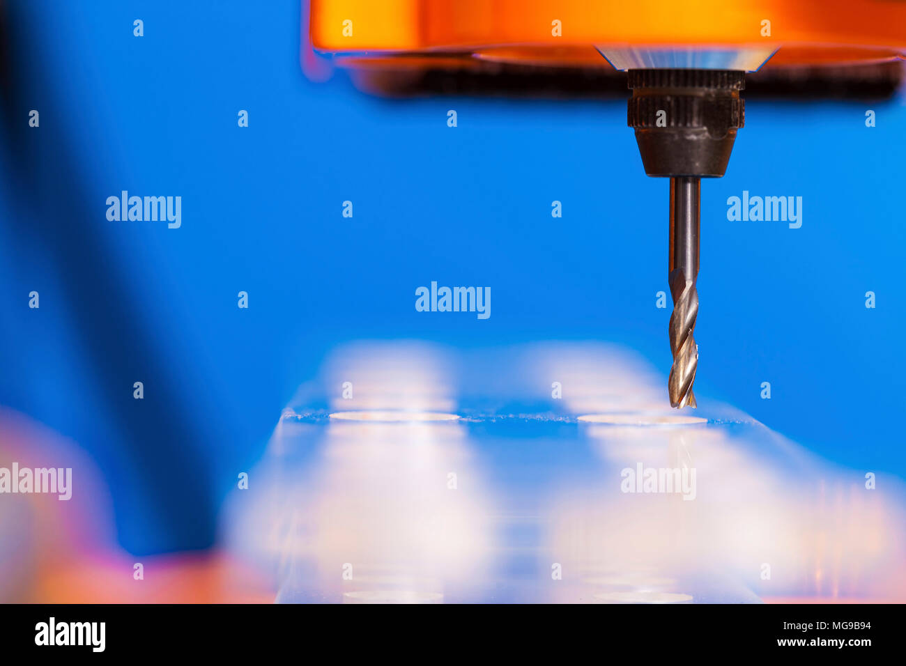 CNC milling machine drilling plastic block# Stock Photo - Alamy