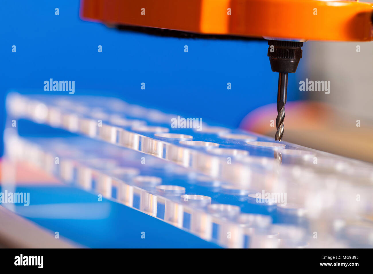 CNC milling machine drilling plastic block# Stock Photo - Alamy