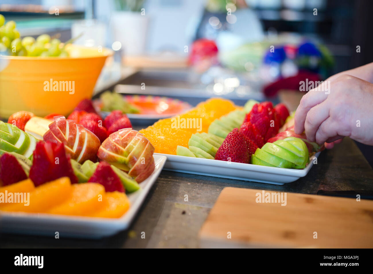 Preparing and slicing on the kitchen table of delicious fruits: apples ...