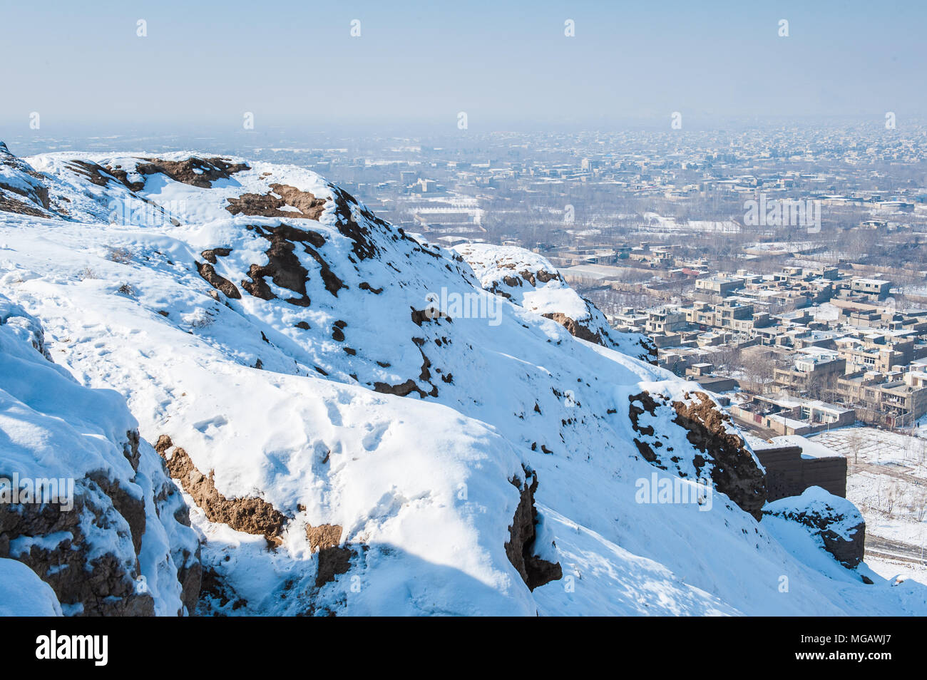Rock in snow Stock Photo - Alamy