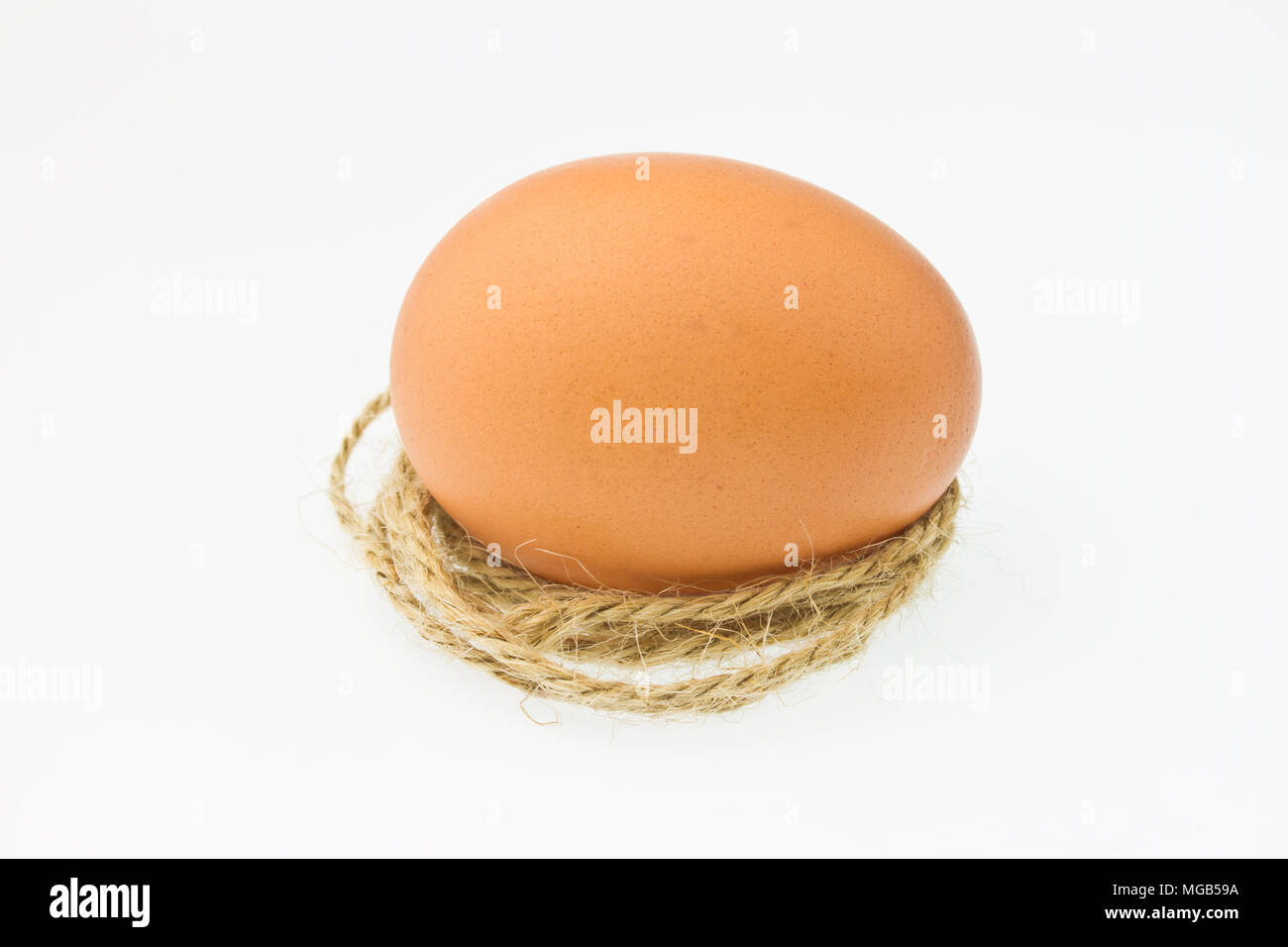 egg on brown tied rope, isolated and white background Stock Photo - Alamy