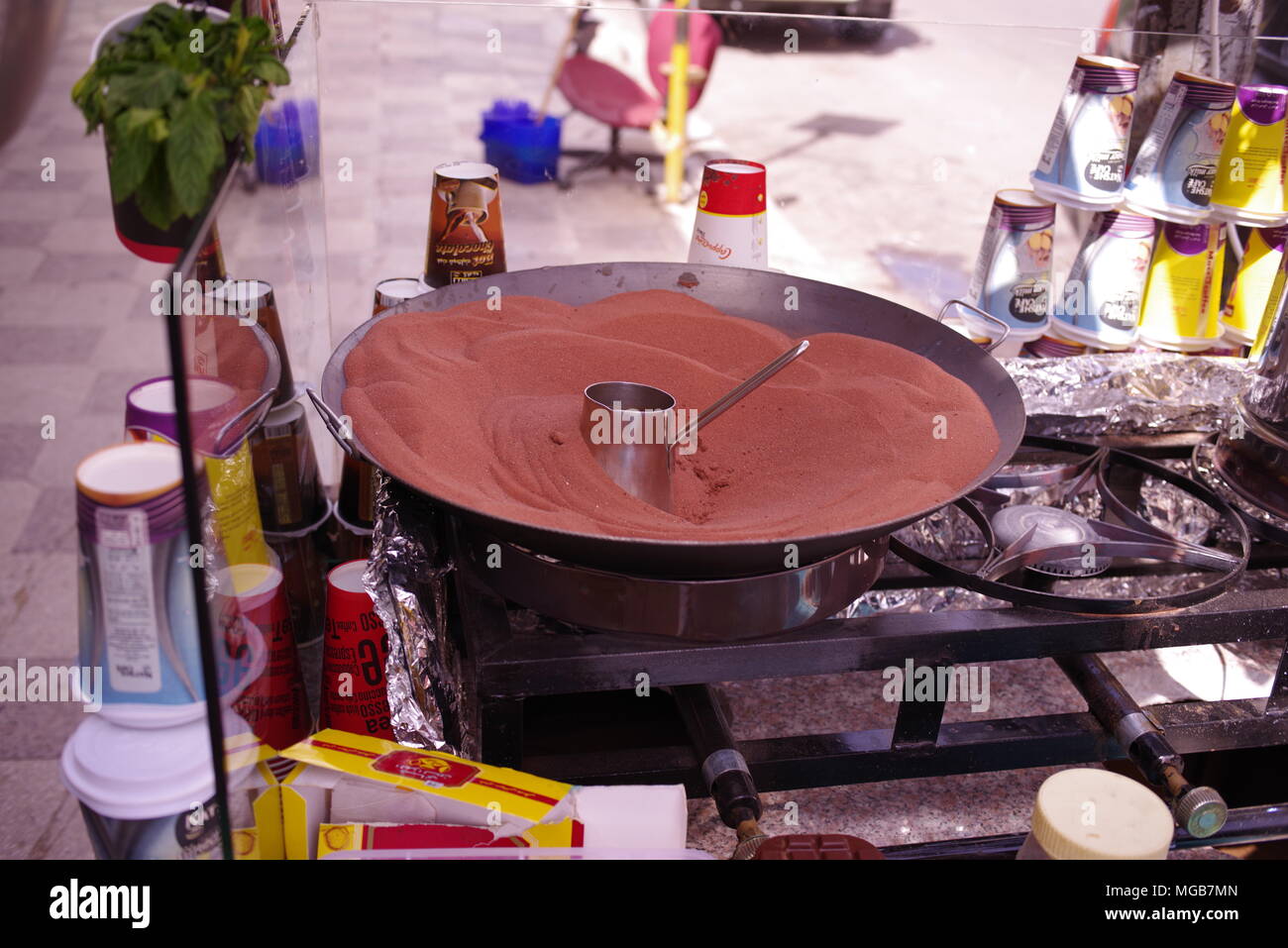 Street vendor cooking Arabic coffee in heated sand in Aqaba, Jordan ...