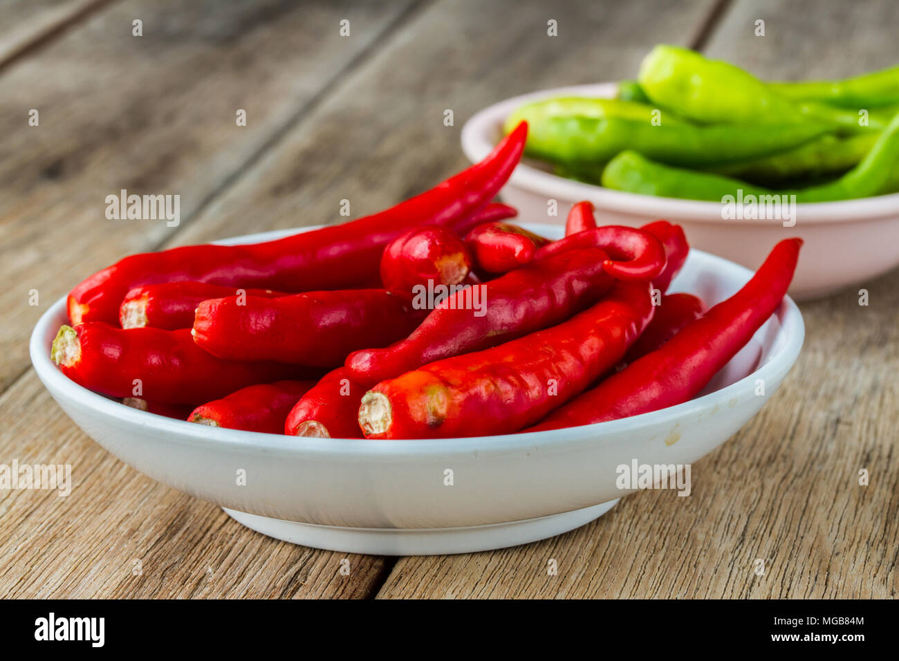 Red hot chili paper in cup on old wooden table Stock Photo - Alamy