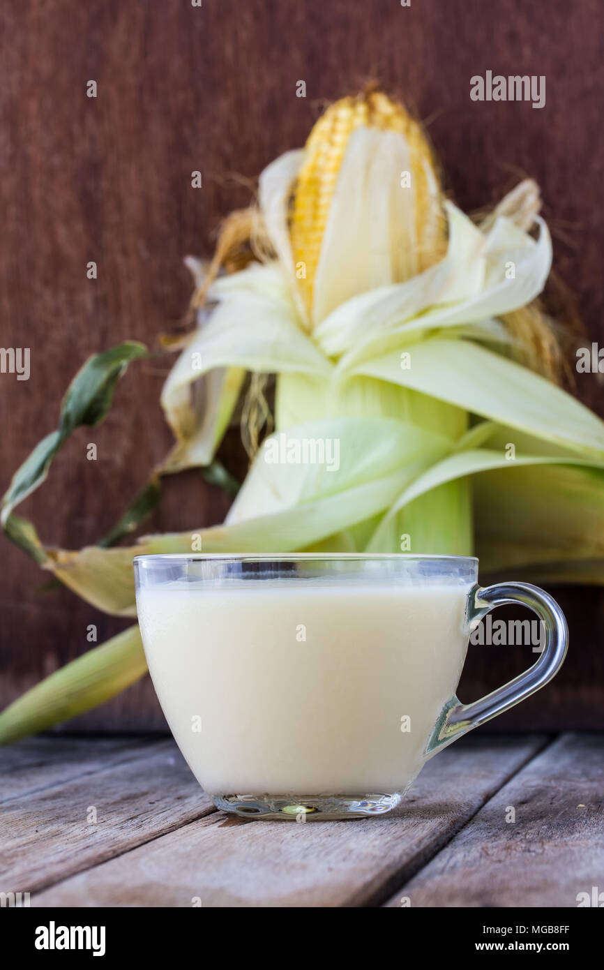 Corn water in a glass on a wood table Stock Photo - Alamy