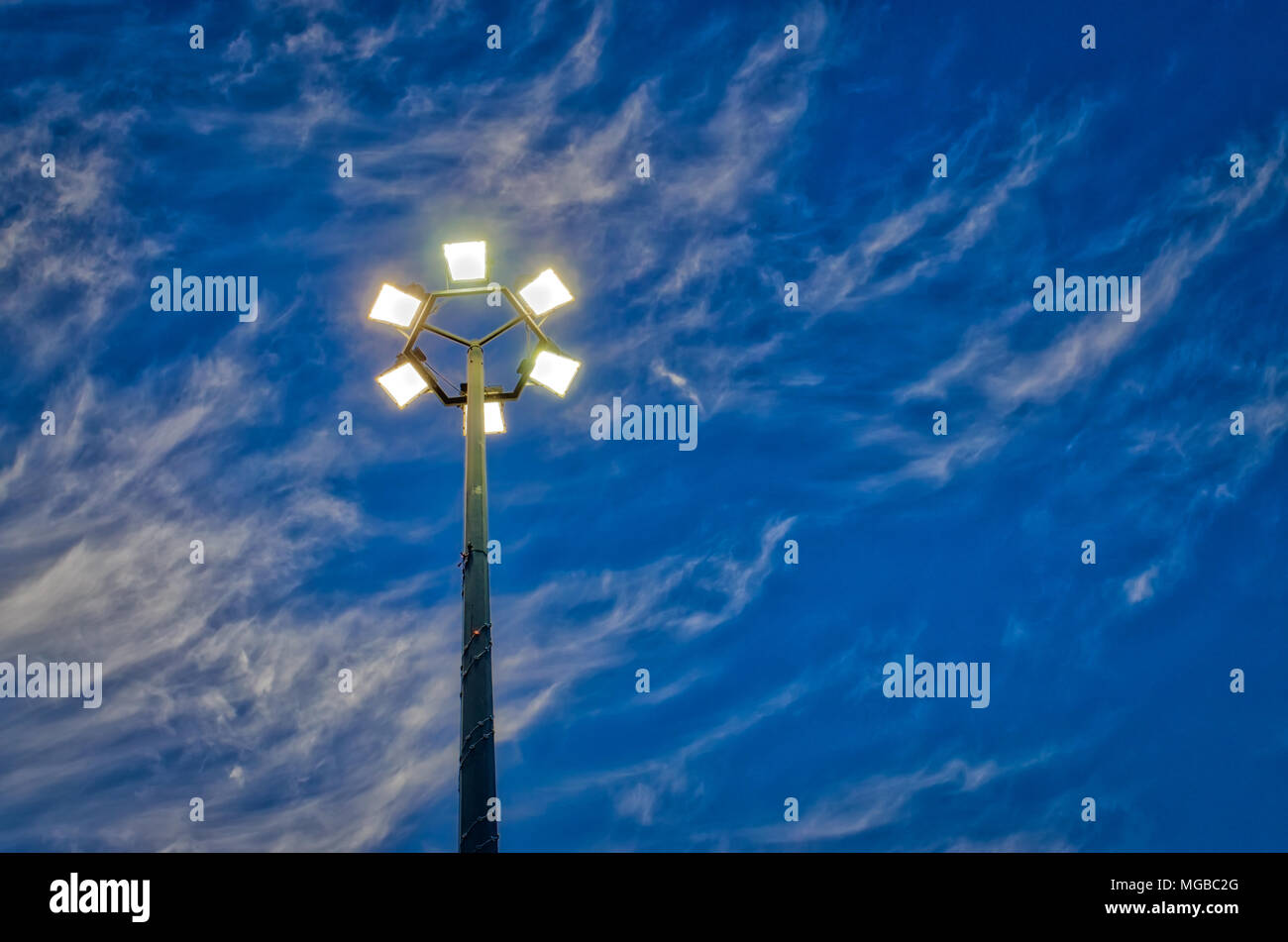 Six streetlights in a hexagonal pattern under a blue sky with dramatic ...