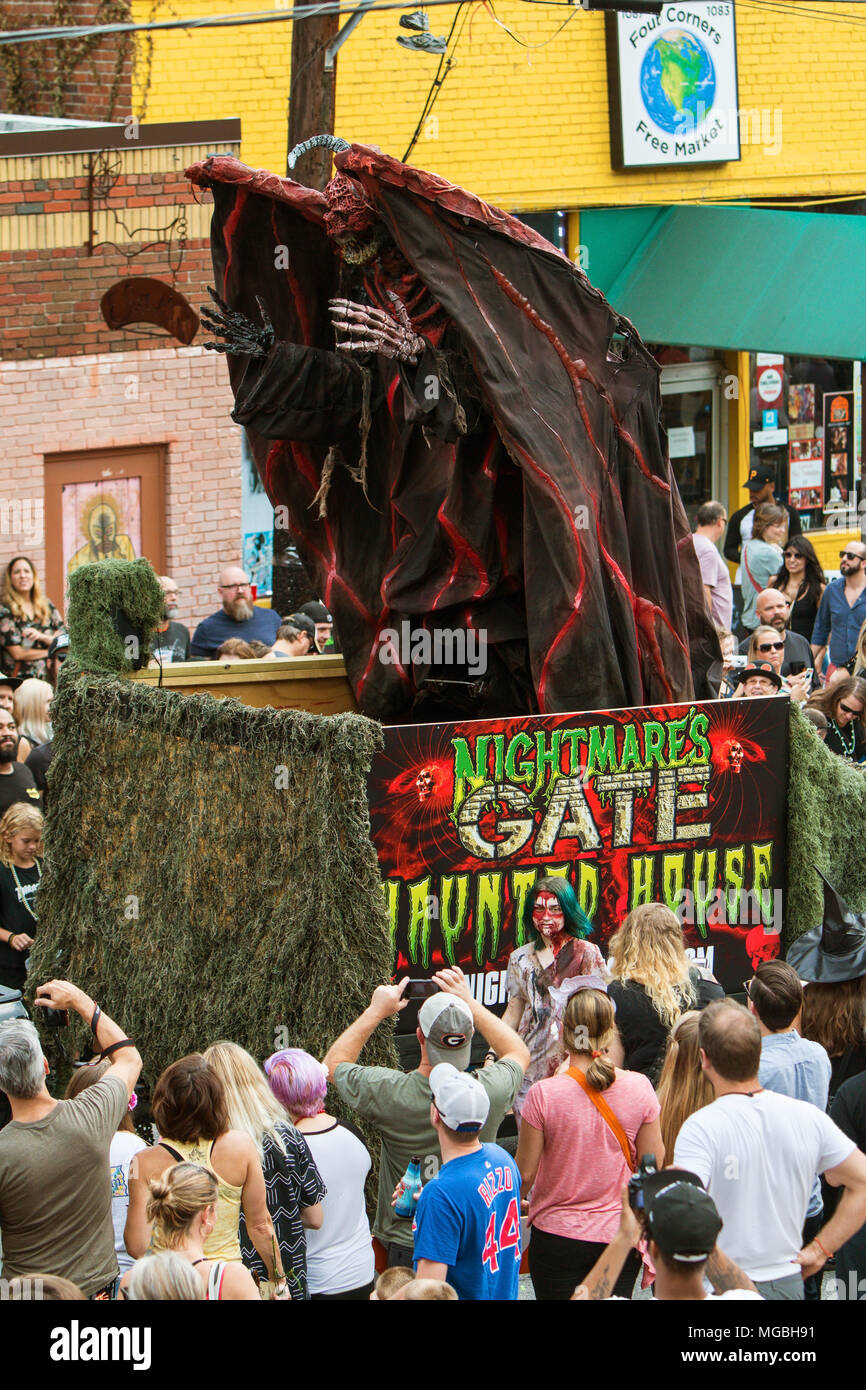 A terrifying demonic monster rises up via hydraulics on a parade float ...