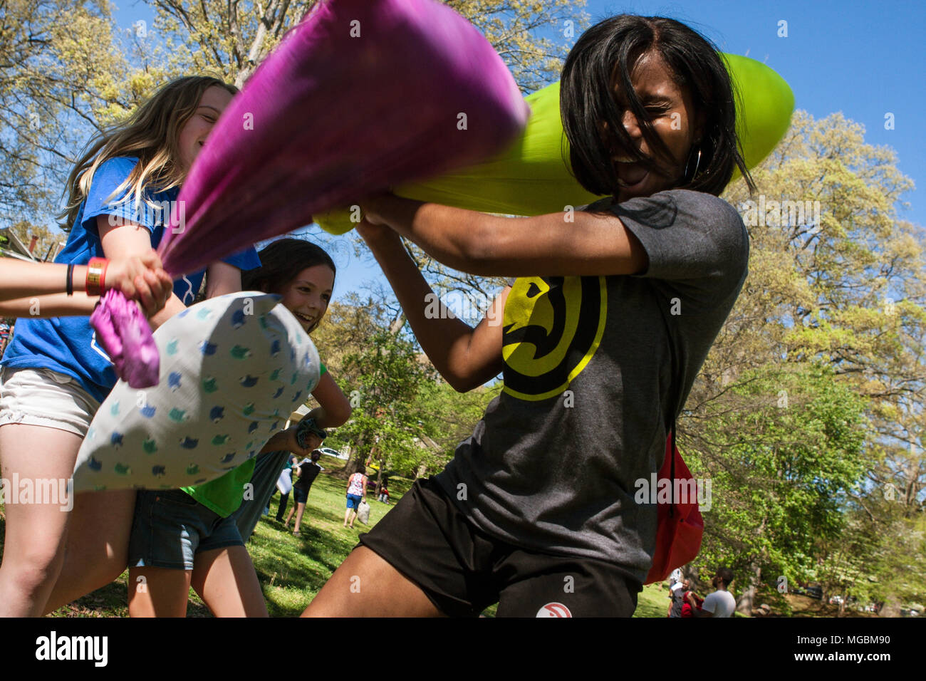 A Young Adult Woman Fends Off The Pillow Attacks Of Several Girls As