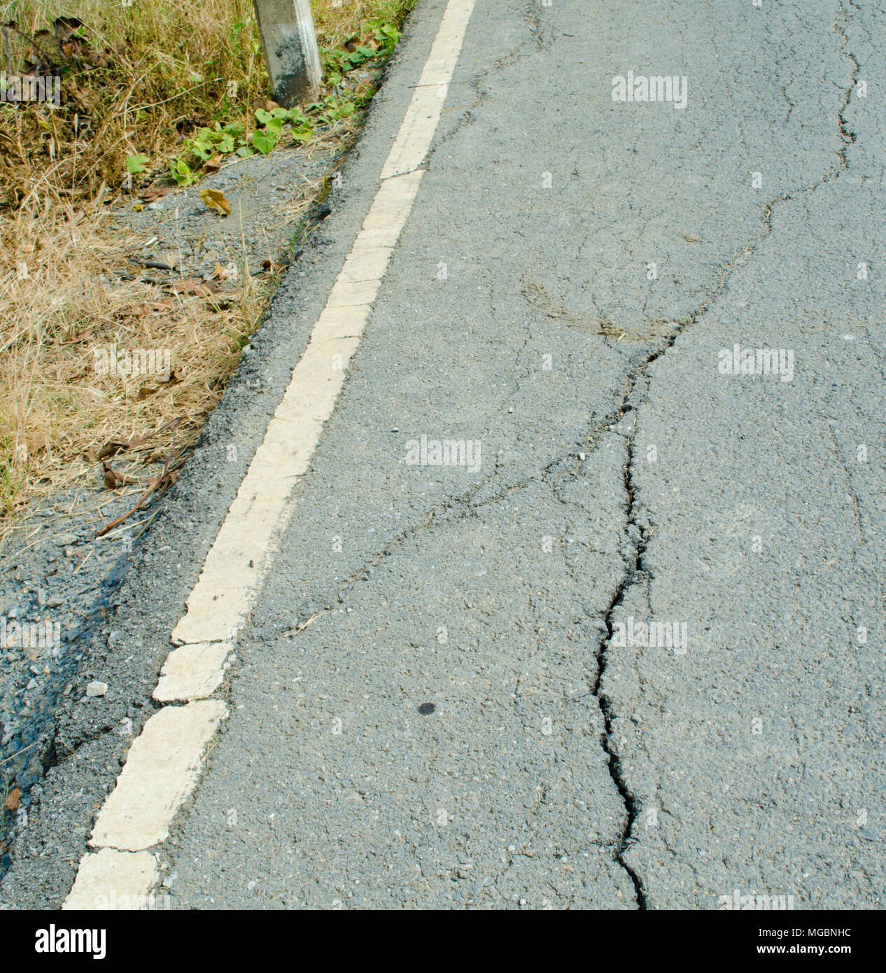Broken asphalt. Side along the asphalt road collapsed because of ...
