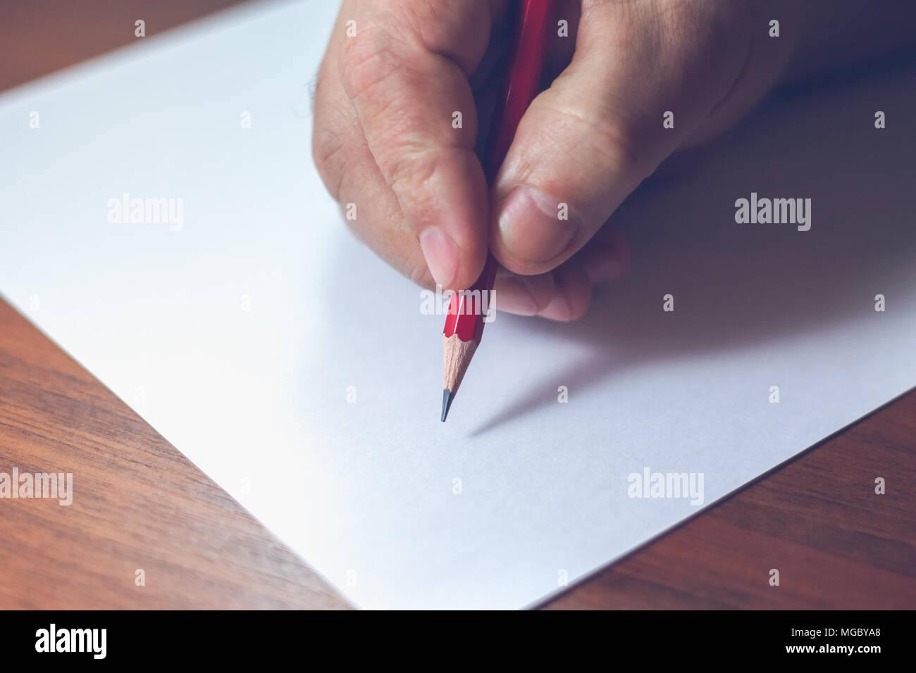 A close photo of a persons writing a letter with a pencil Stock Photo ...