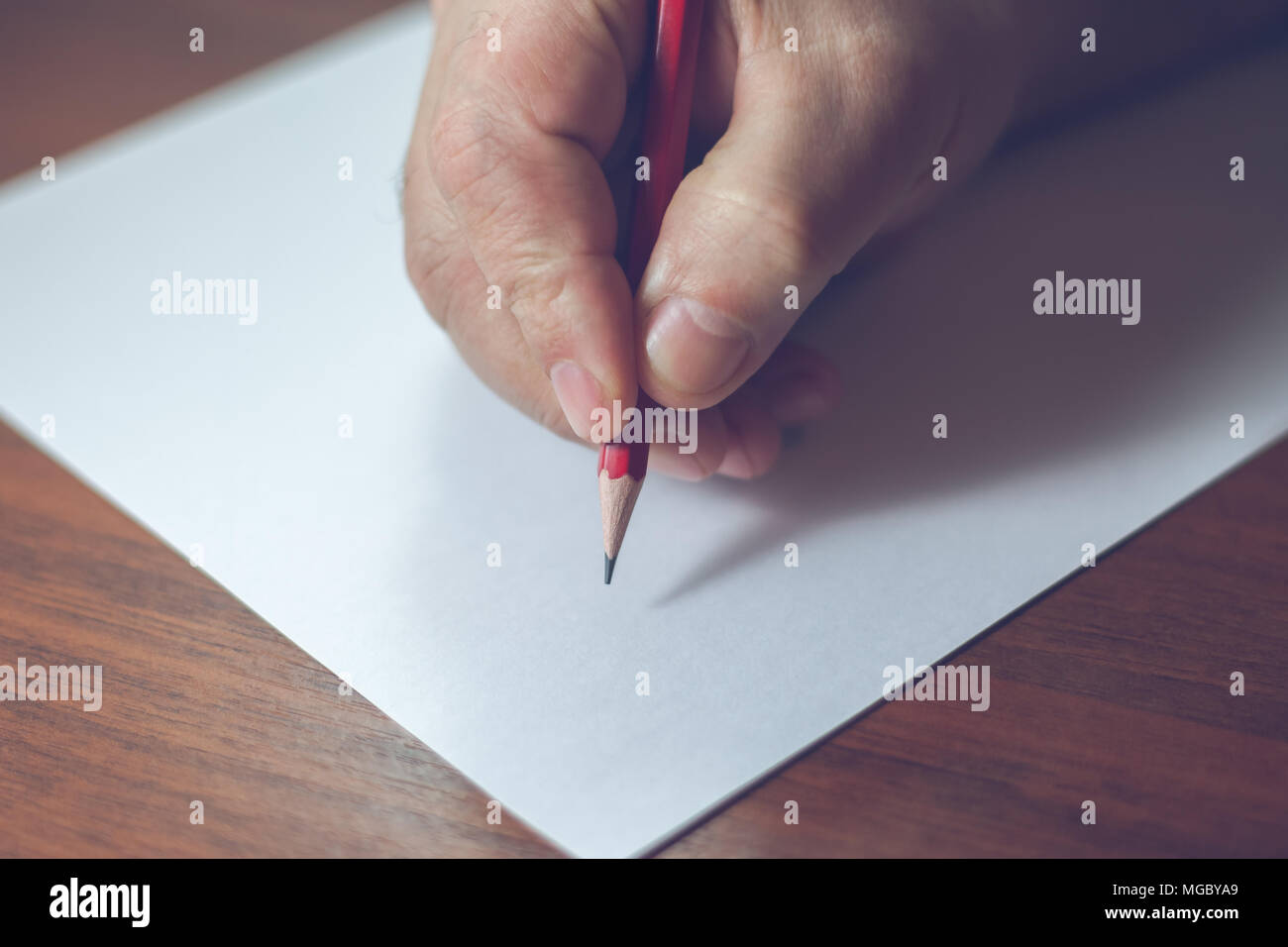 A close photo of a persons writing a letter with a pencil Stock Photo ...