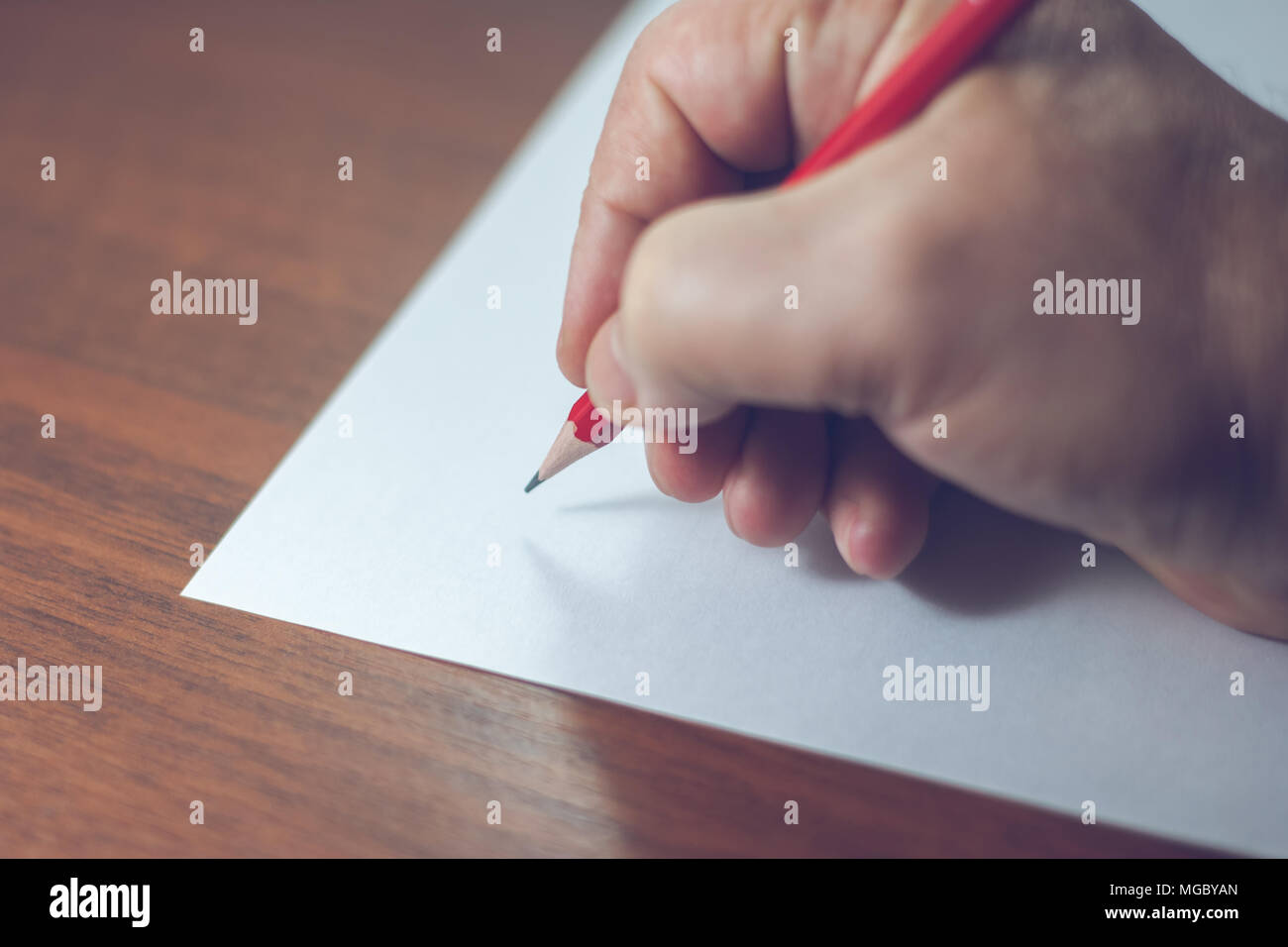 A close photo of a persons writing a letter with a pencil Stock Photo ...