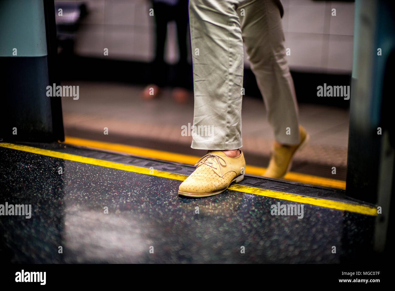 A man walks onto a London train on the London Underground Tube Stock ...
