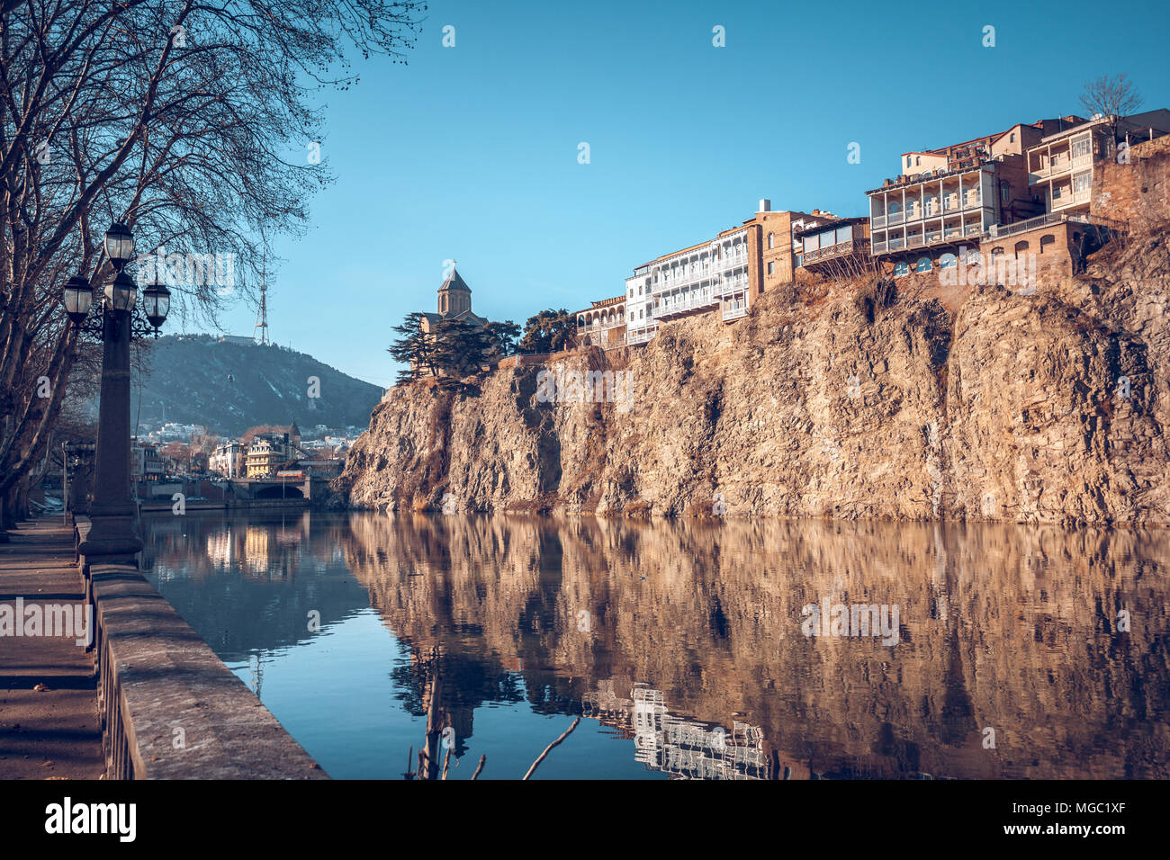 Metekhi church and Houses on the edge of a cliff above the river Kura ...