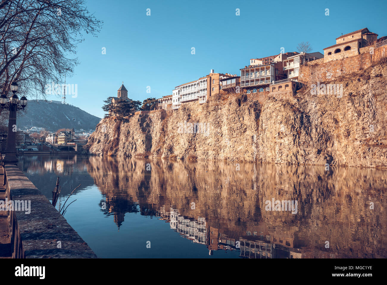 Metekhi church and Houses on the edge of a cliff above the river Kura ...