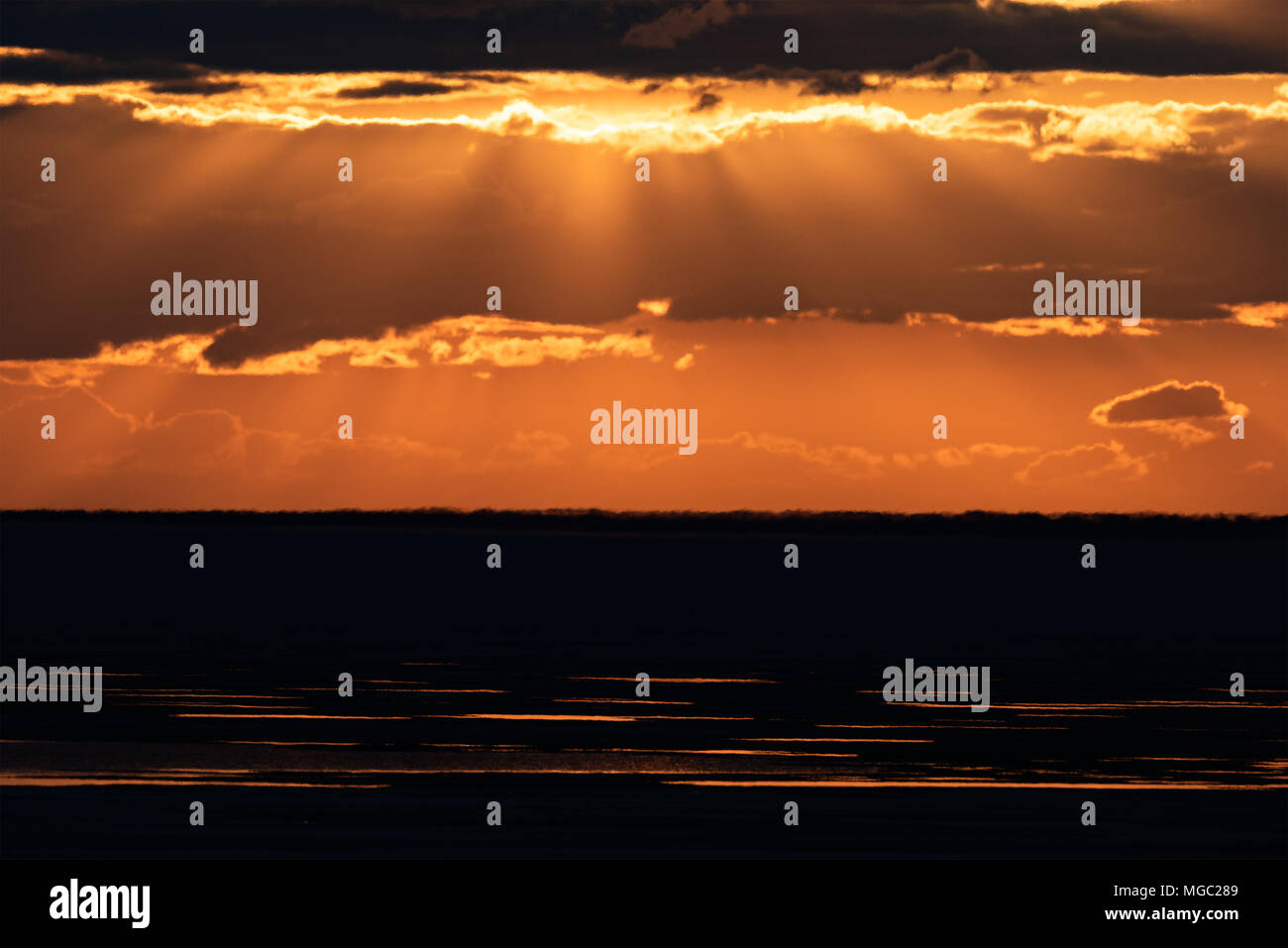 Last rays of setting sun painted sky in yellow and orange colors ...