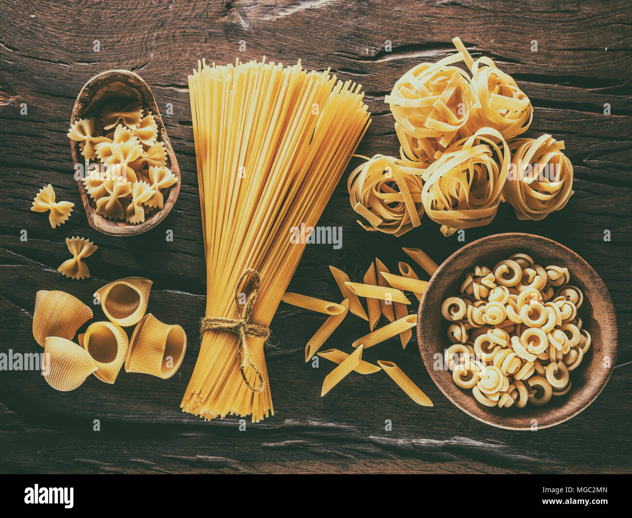 Different pasta types on the wooden table. Top view Stock Photo - Alamy