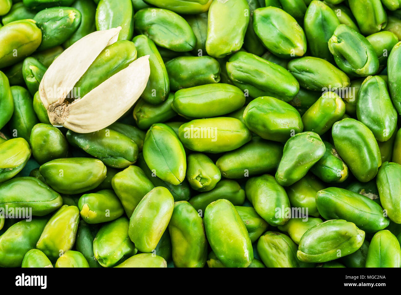 Lot of green pistachio nuts. Food background Stock Photo - Alamy