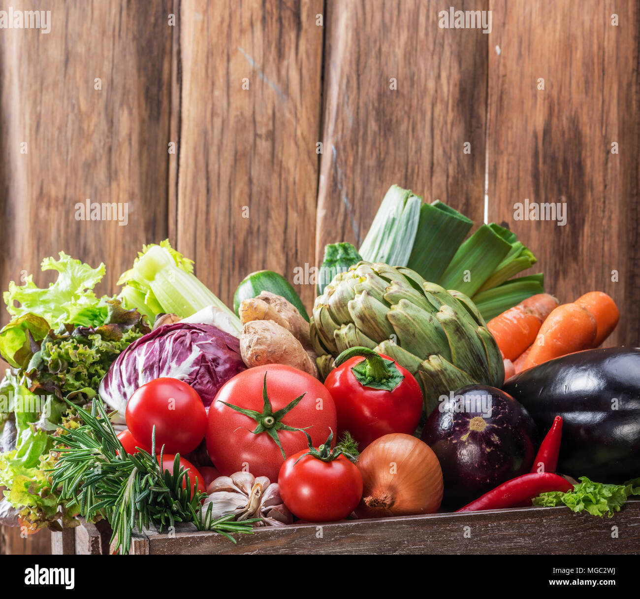 Fresh multi-colored vegetables in wooden crate. Wooden background Stock ...