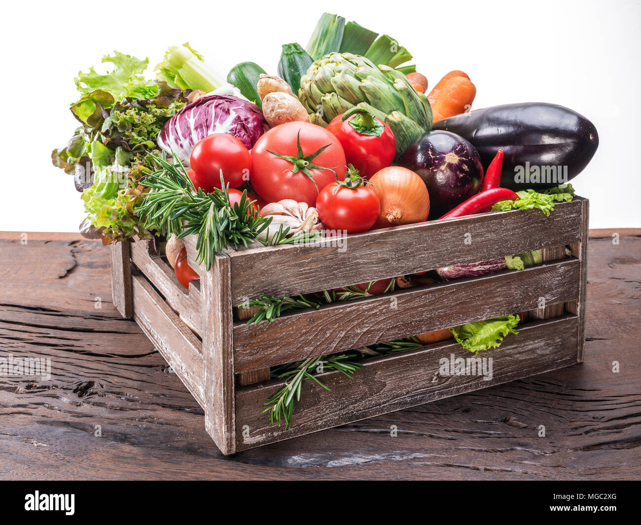 Fresh multi-colored vegetables in wooden crate Stock Photo - Alamy