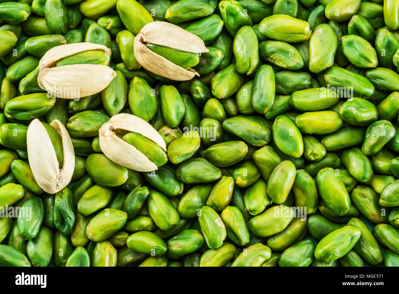Lot of green pistachio nuts. Food background Stock Photo - Alamy