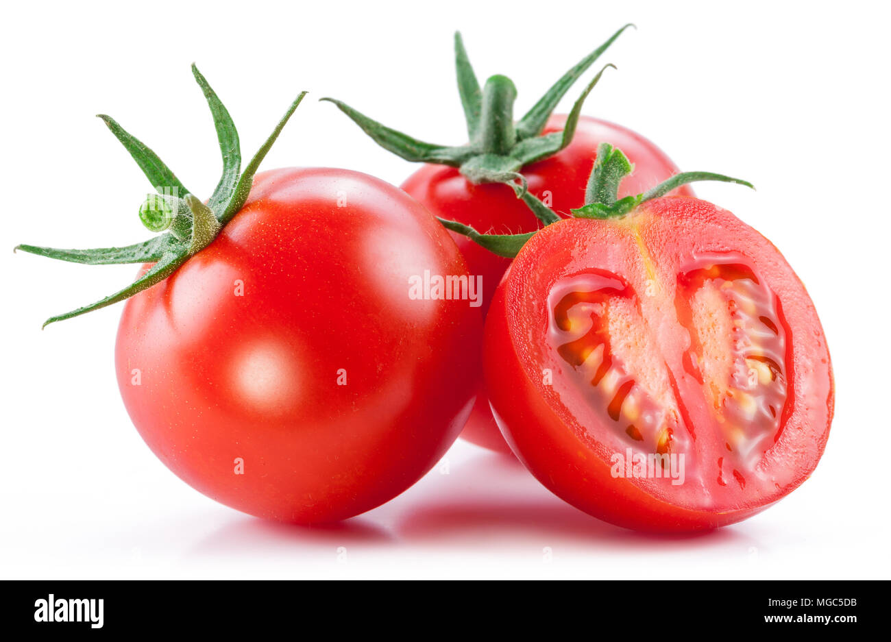 Two cherry tomatoes and a cross section of tomato isolated on white ...