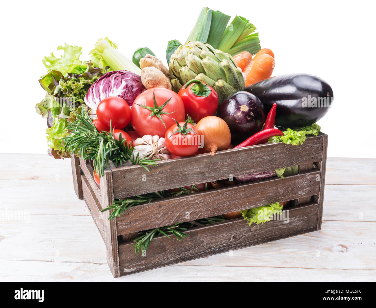 Fresh multi-colored vegetables in wooden crate. White background Stock ...