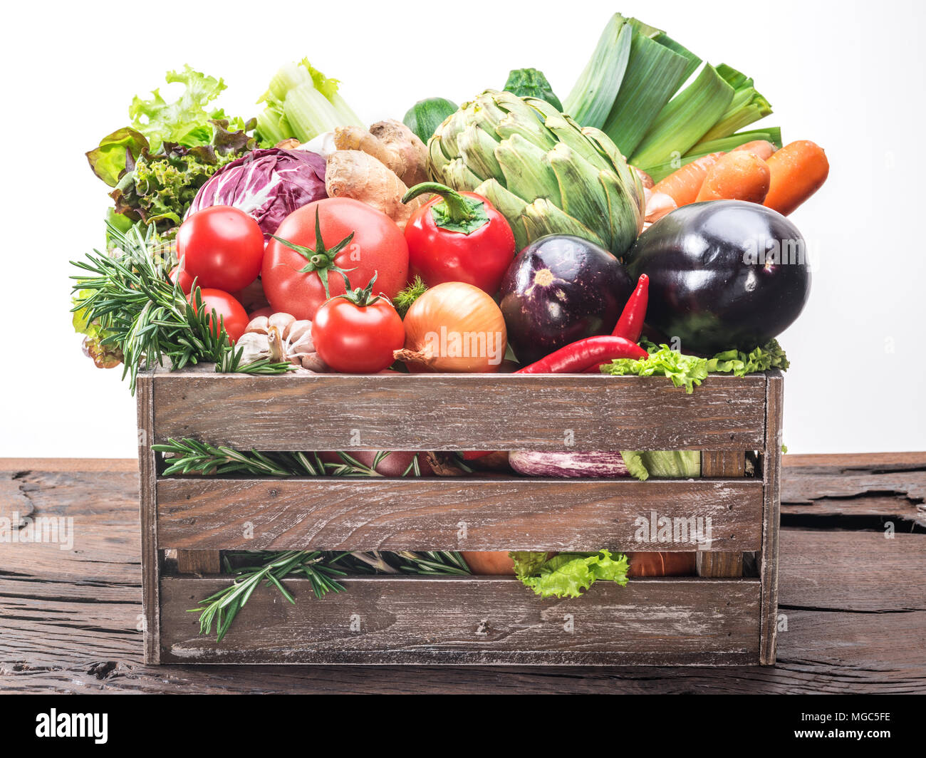 Fresh multi-colored vegetables in wooden crate Stock Photo - Alamy