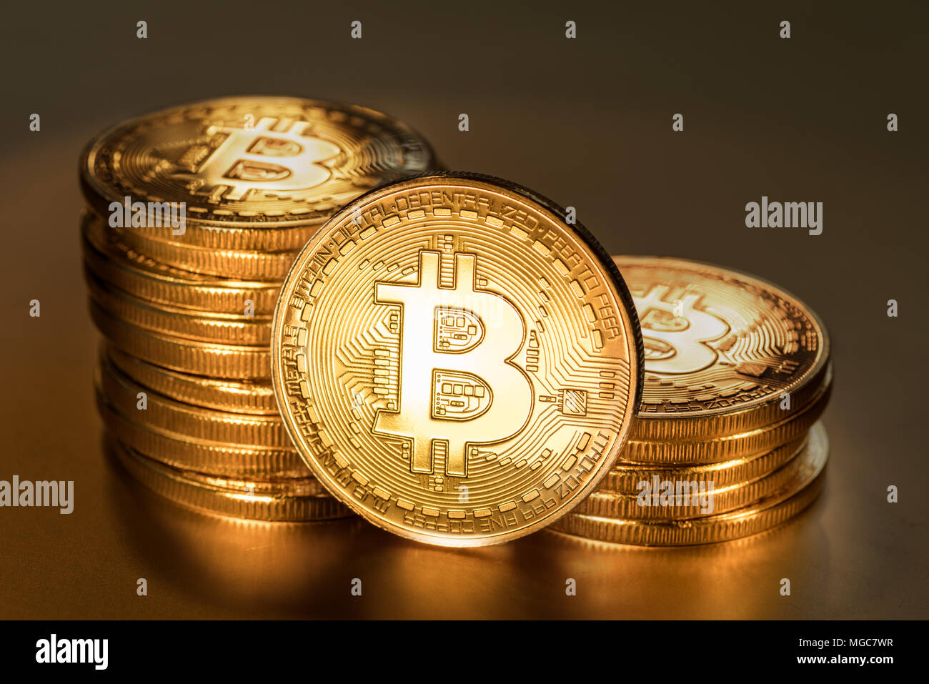 Shiny physical bitcoins on golden background. Blockchain technology ...