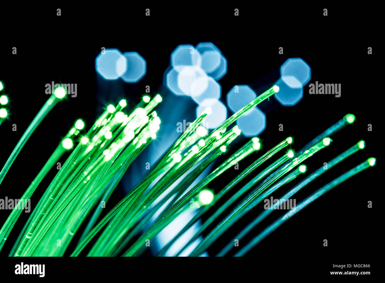 Bundle of optical fibers with green light. Black background Stock Photo ...