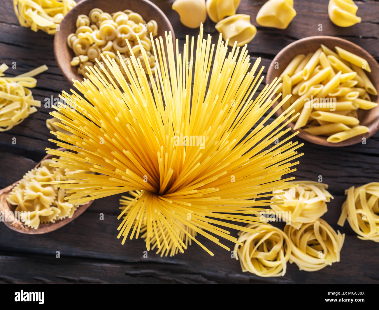 Different pasta types on the wooden table. Top view Stock Photo - Alamy