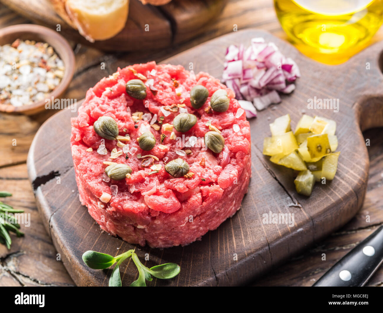 Steak tartare served with capers, pickled cucumbers and chopped onion ...