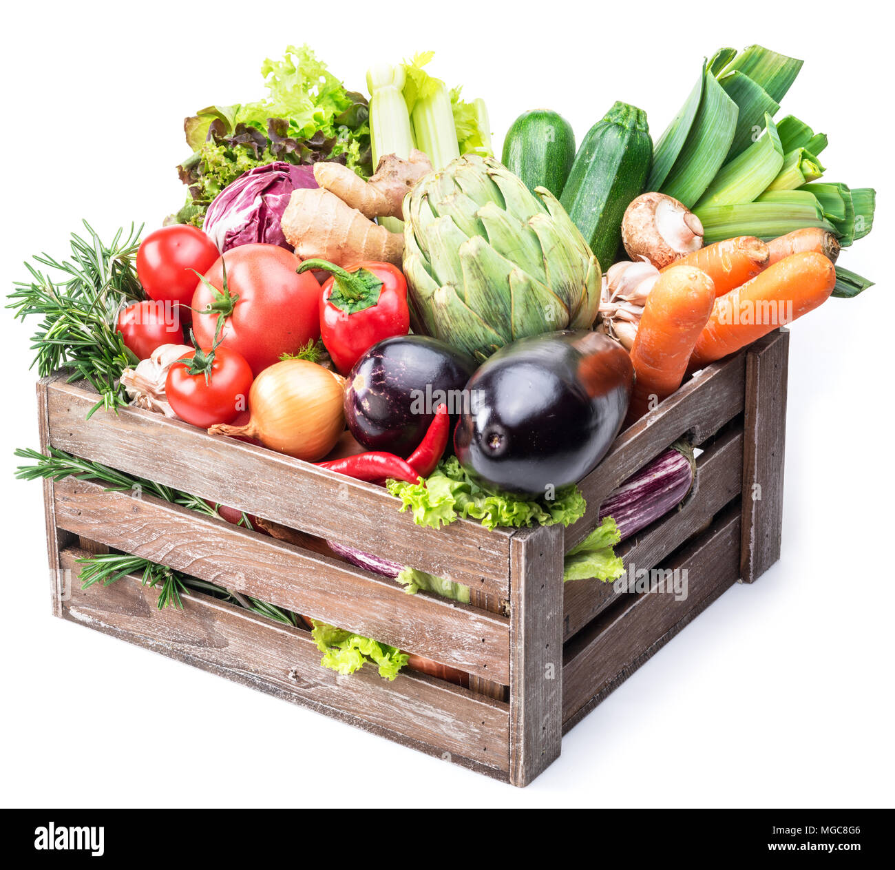 Fresh multi-colored vegetables in wooden crate. White background Stock ...
