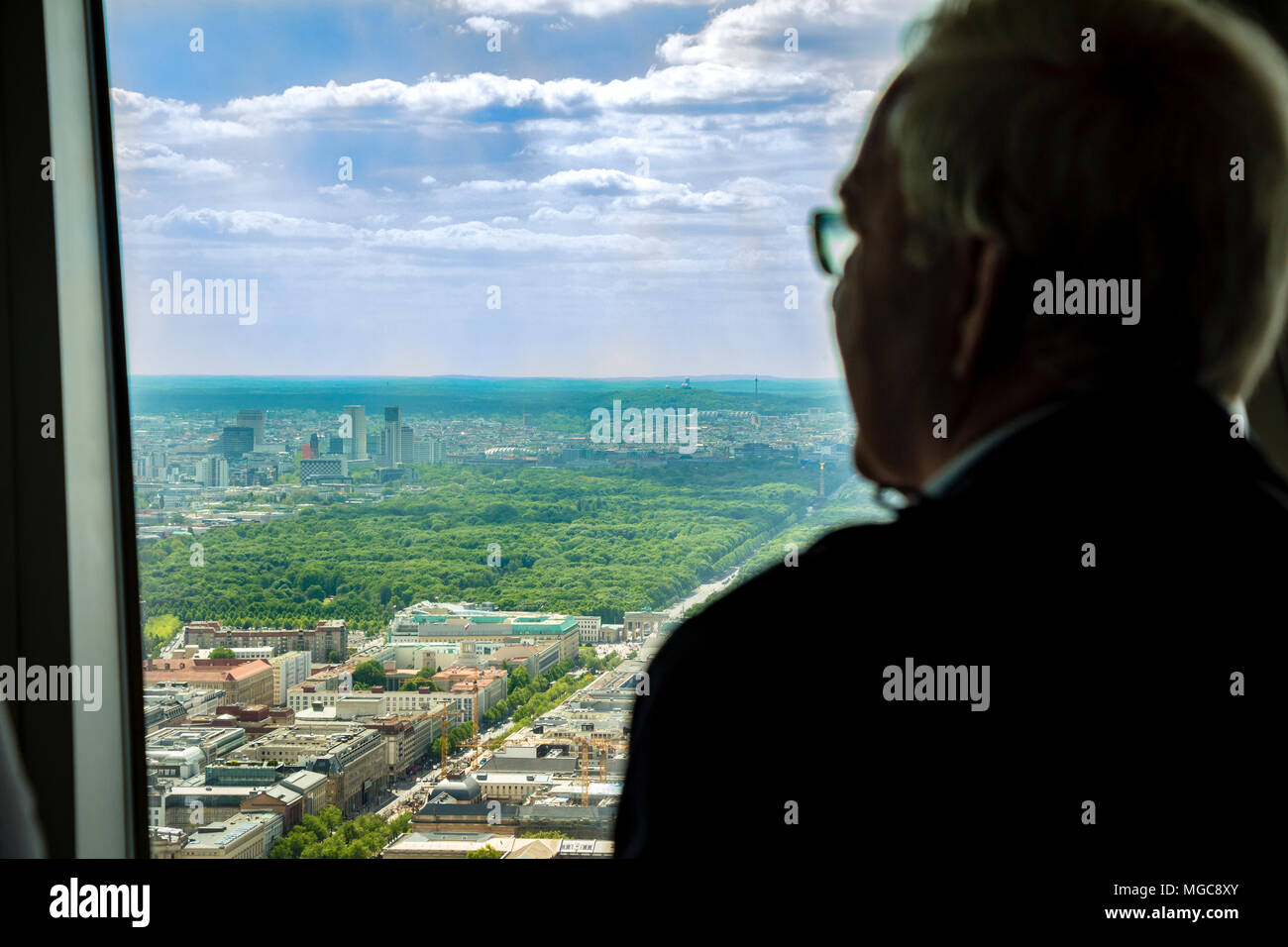 Silhouette of back view of man looking out of a window at the berlin ...
