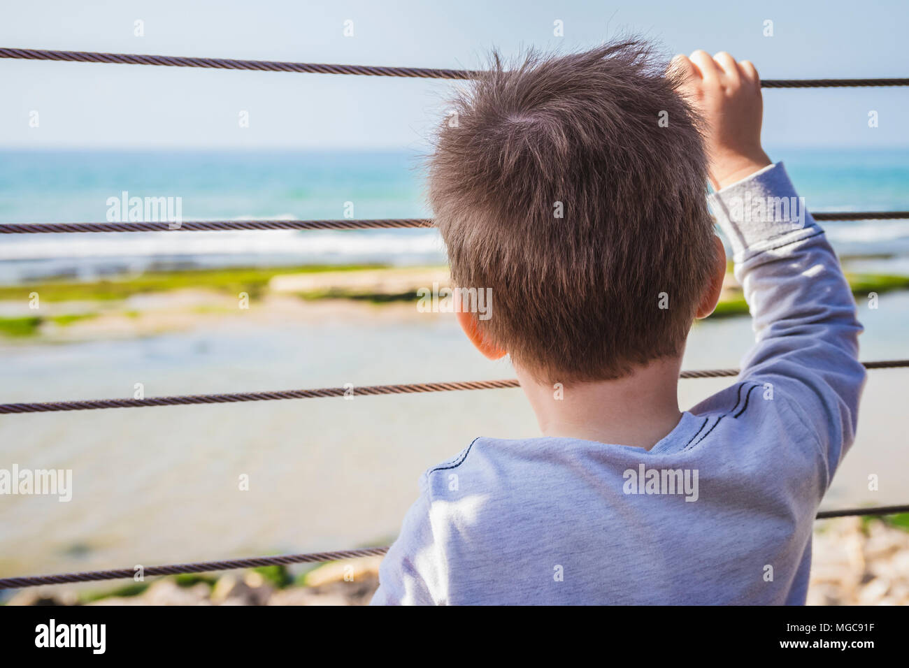 Boy Standing Behind Fence High Resolution Stock Photography and Images ...