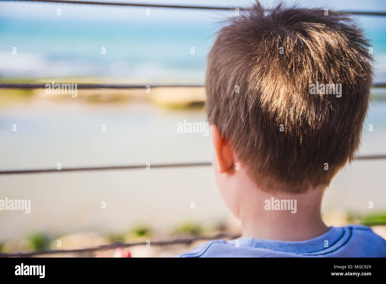 Boy Standing Behind Fence High Resolution Stock Photography and Images ...