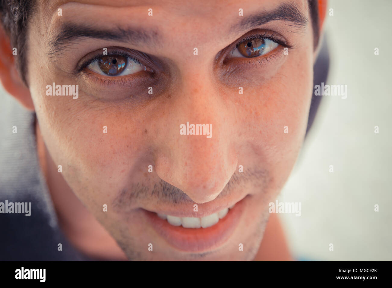 Close up top view portrait of a young man looking at camera with ...