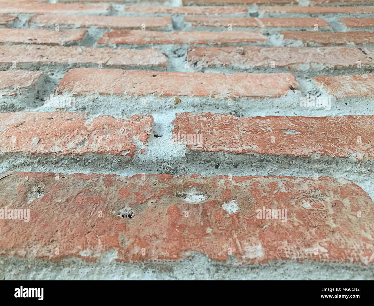 Red brick wall surface shooting from below to top view Stock Photo - Alamy