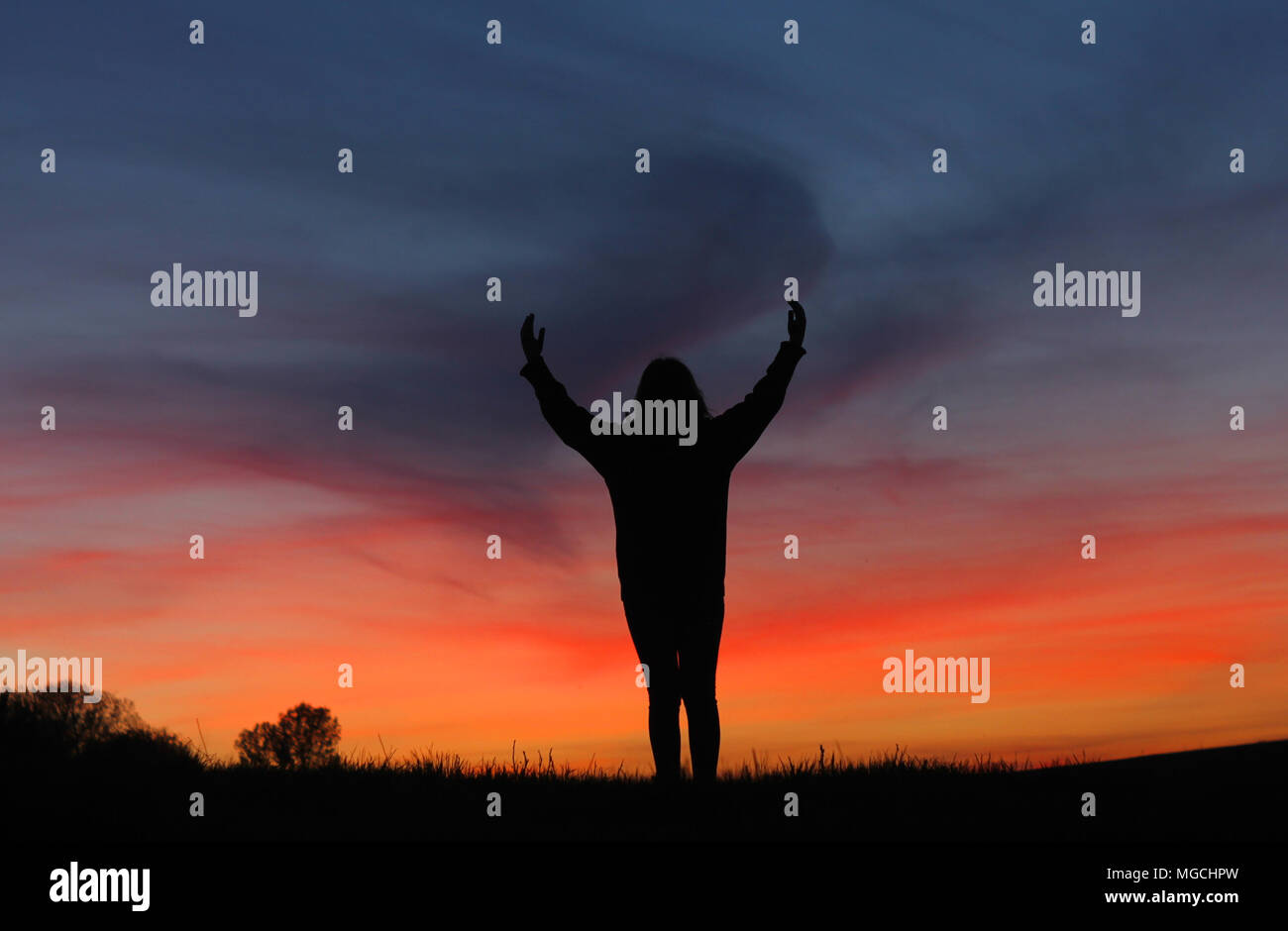 Women are lifting their hands up in the sky at sunset, enjoyment of ...