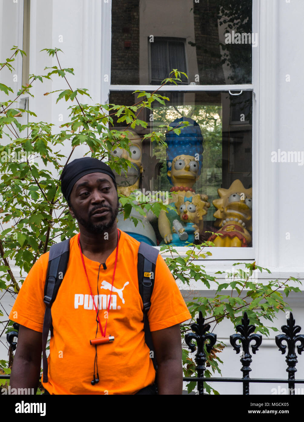 Man standing in front of building, characters from The Simpsons placed ...