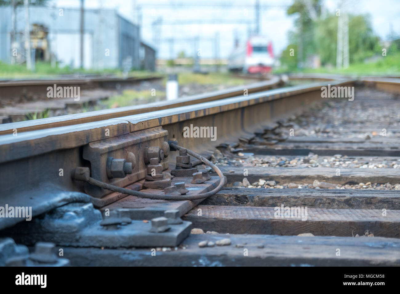 The passenger train enters the railway station Stock Photo - Alamy