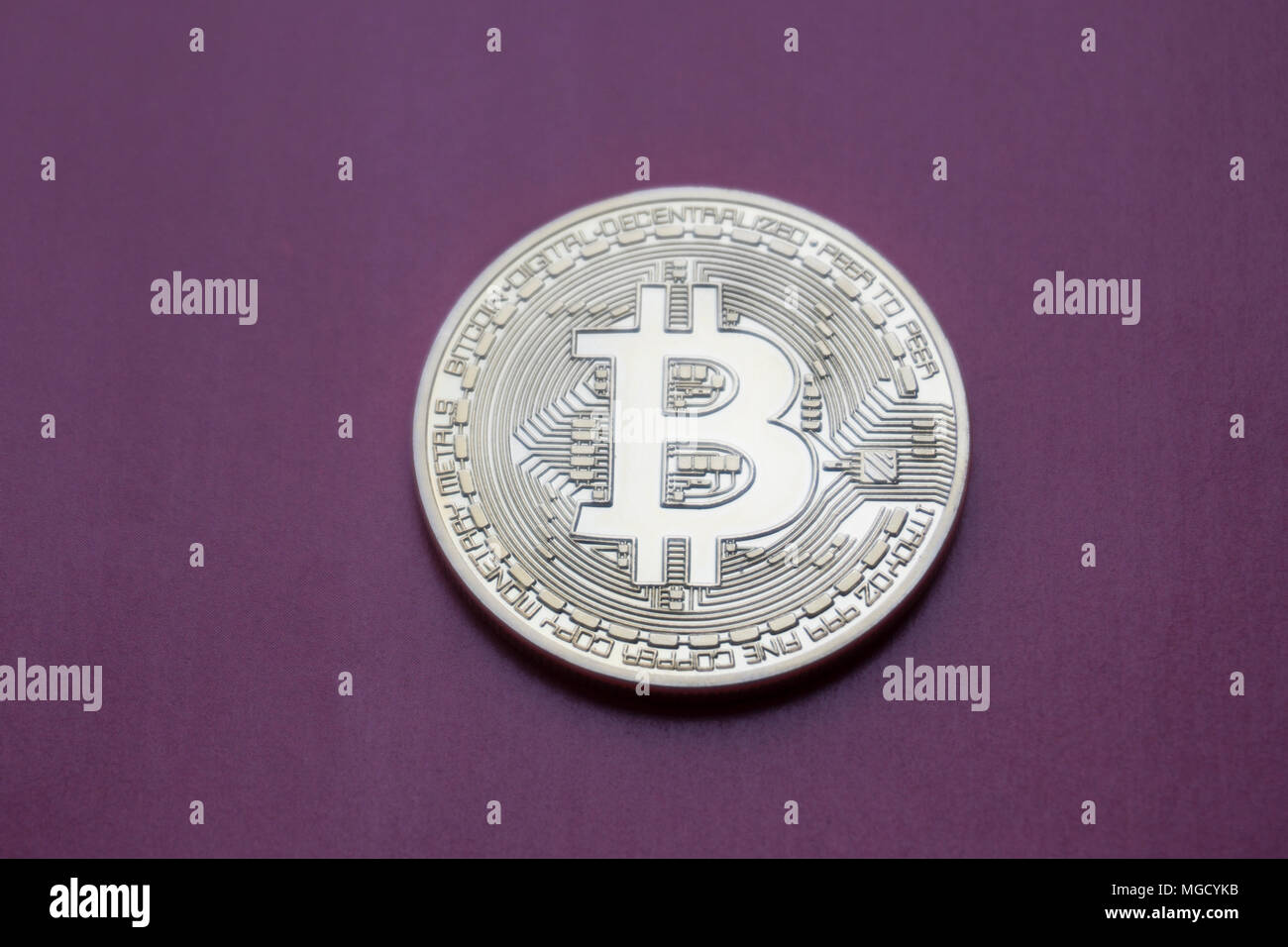 Golden Bitcoins (digital virtual money) on a purple background Stock ...