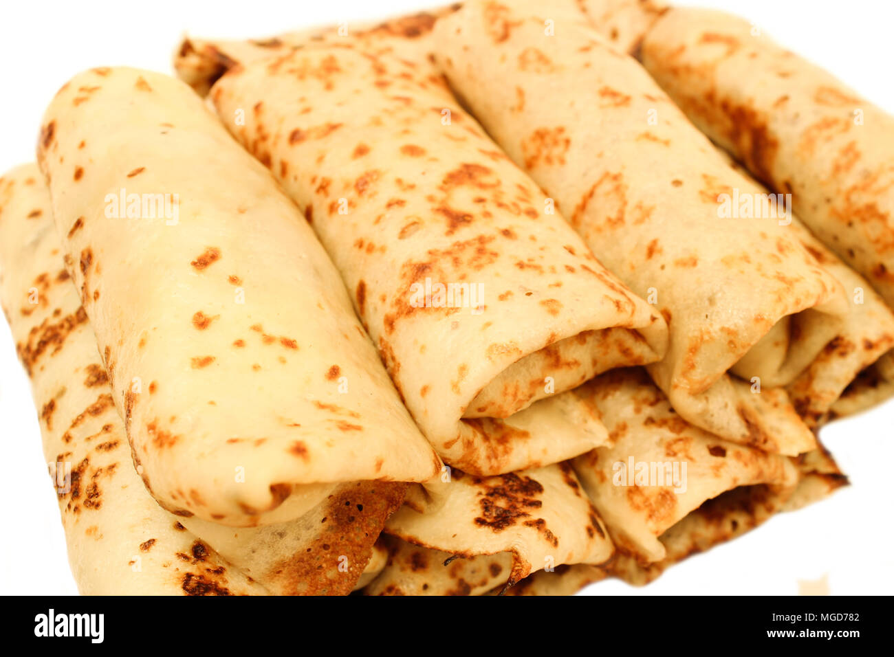 Russian pancakes with fillings wrapped in them isolated on white ...