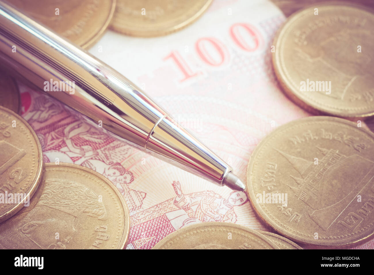 Pen and coins with filter effect retro vintage style Stock Photo - Alamy