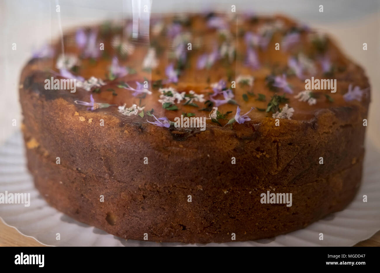 home baked cake with floral petals on display Stock Photo - Alamy