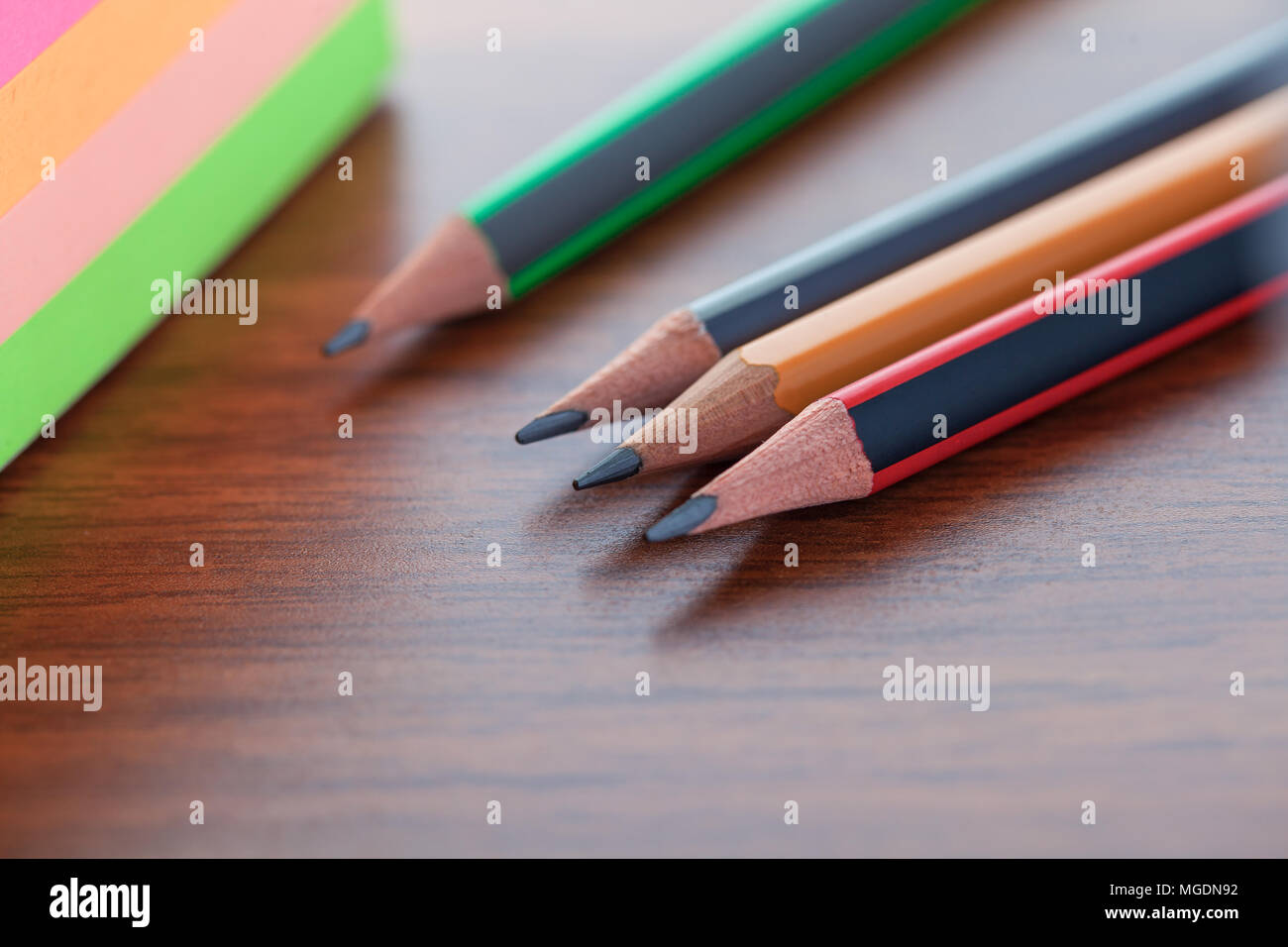 Pencils and sheets on a brown table, a tool for drawing and drawing ...